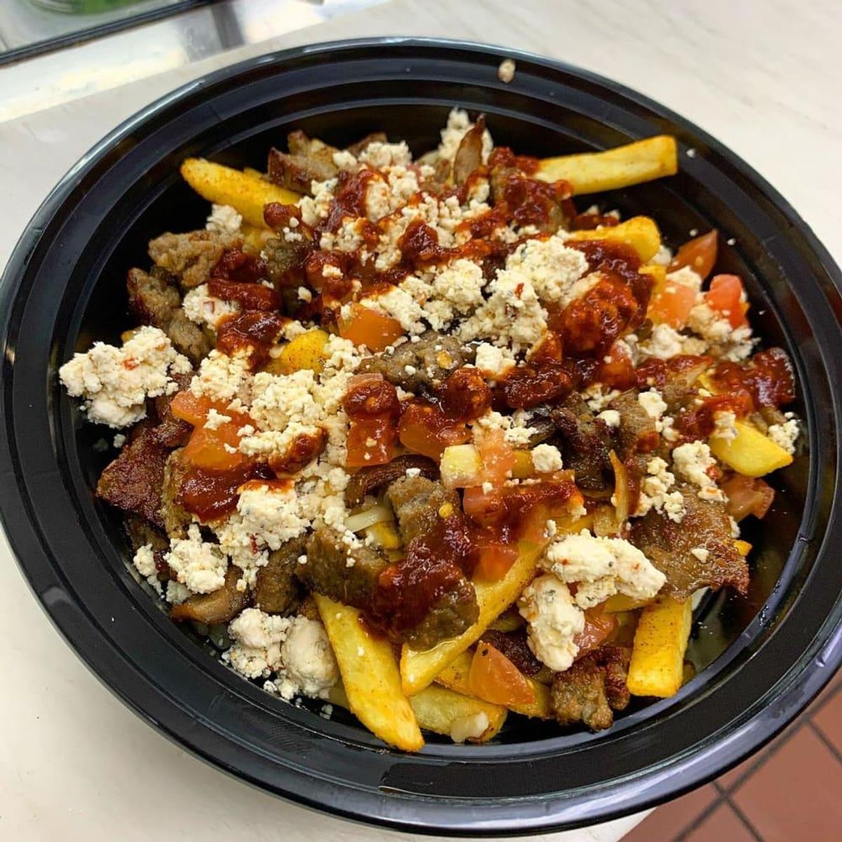 Fusion items like gyro fries are a staple at AL Quick Stop ...