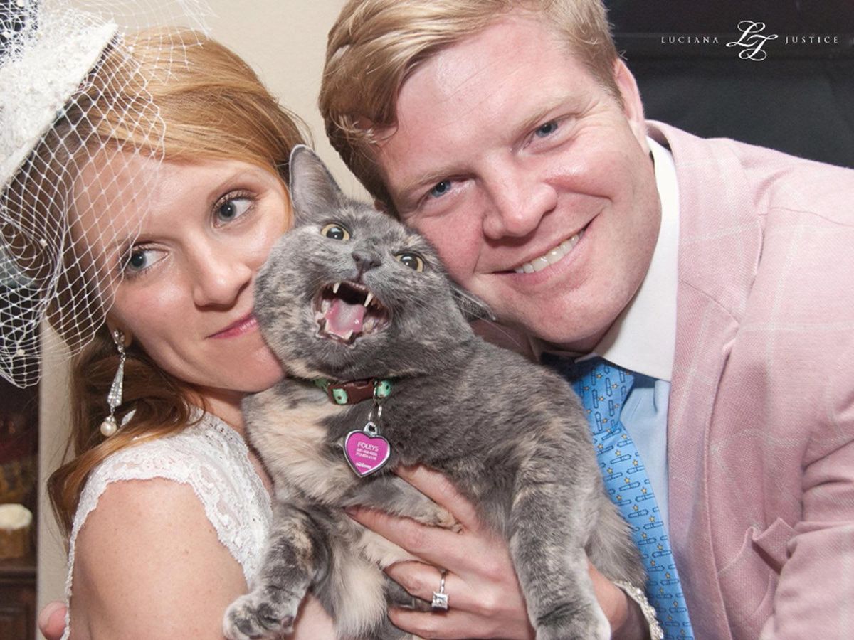 Danielle and Justin Foley pose for a picture with their beloved cat ...