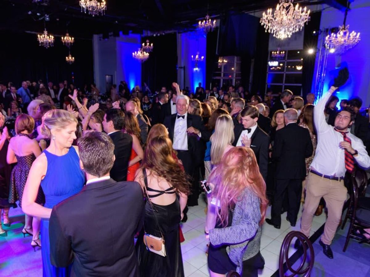 Guests fill the dance floor at the Halo House 007th Annual Gala ...