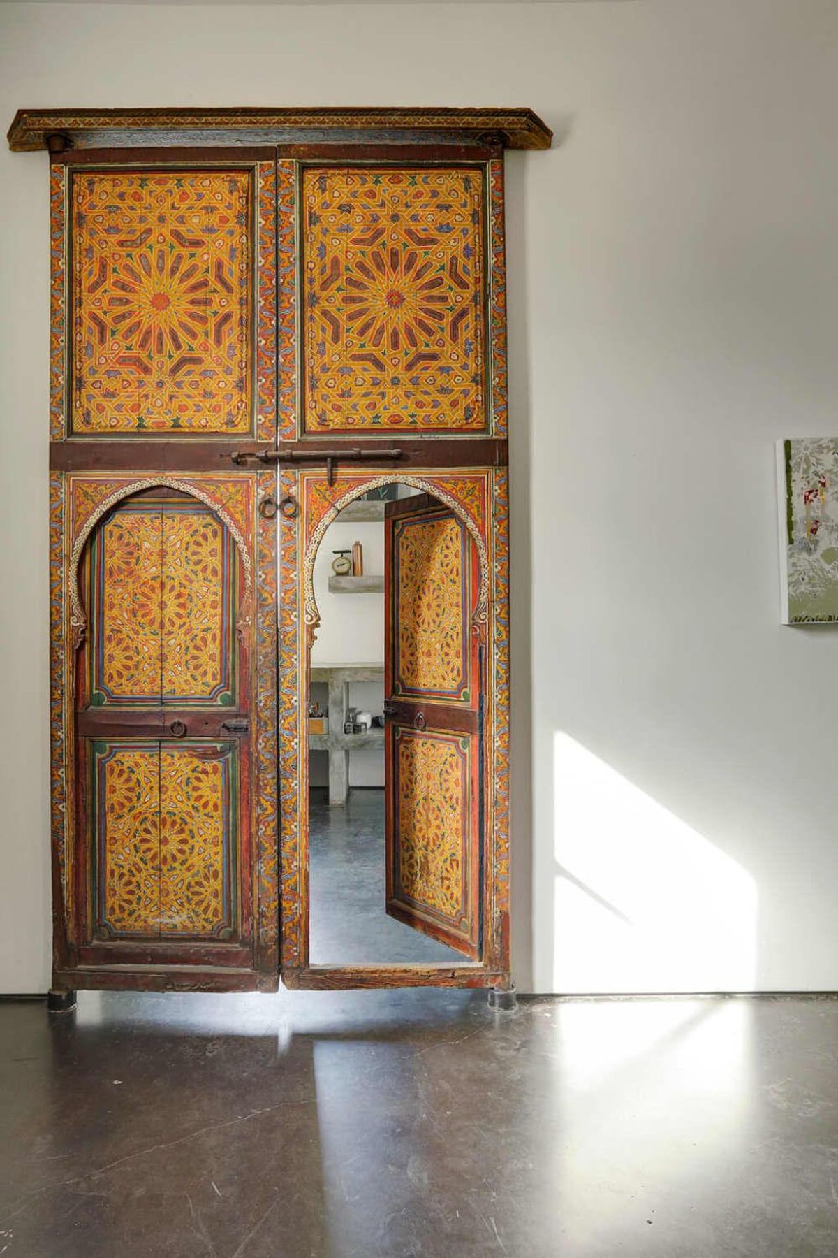 A decorative patterned orange Asian doorway with latched doorway ...