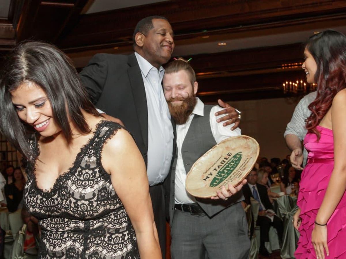 Mark Holley hugs sous chef Kenten Marin. - CultureMap Houston