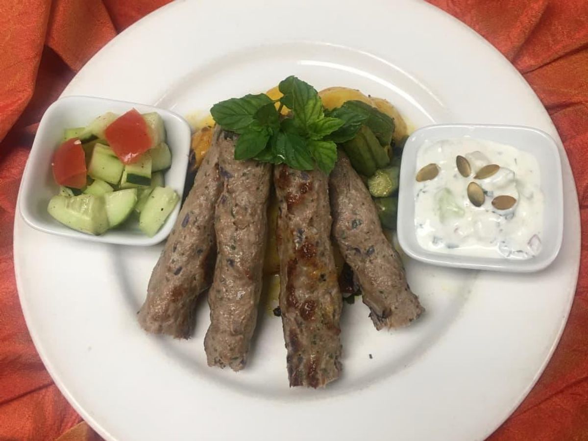 Lamb Seekh kabab with cucumber salad and cumin yogurt. - CultureMap Houston
