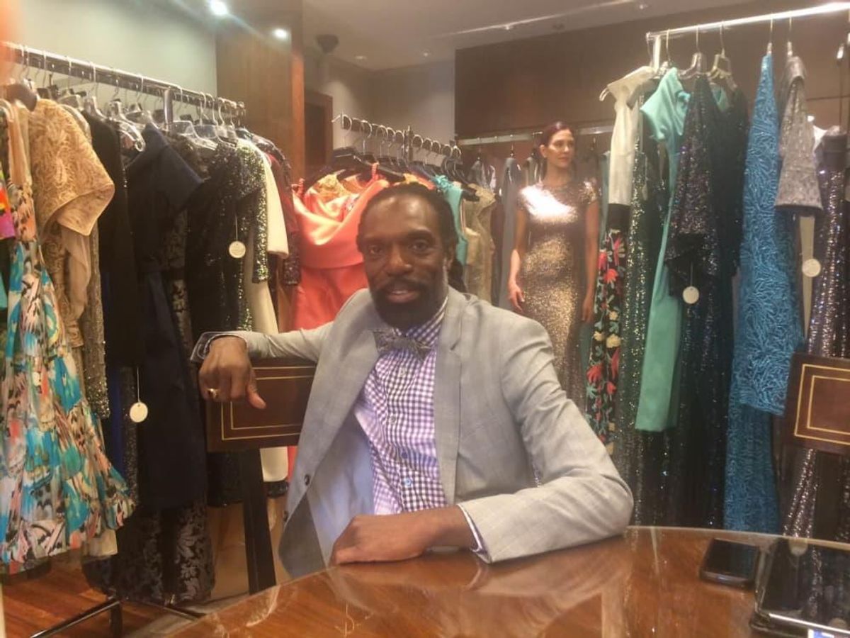 Kevan Hall is surrounded by his fall collection at Elizabeth Anthony ...