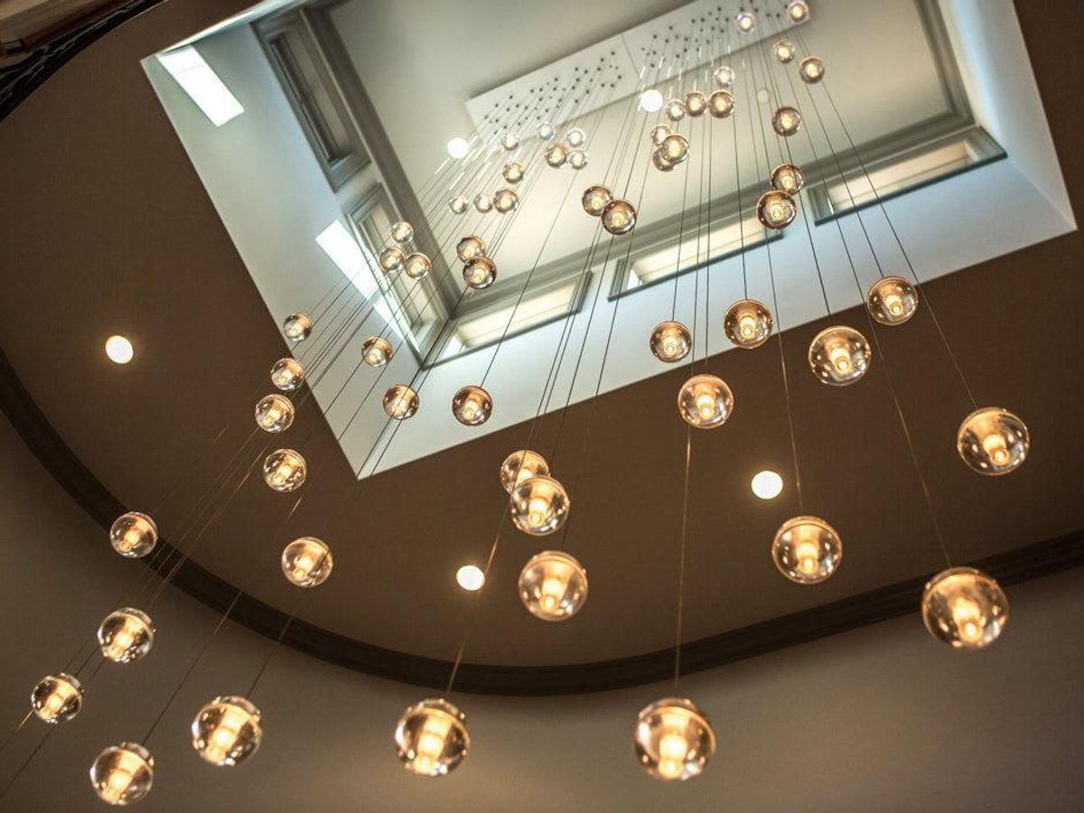 Stunning light fixture is just one contemporary touch. - CultureMap Houston