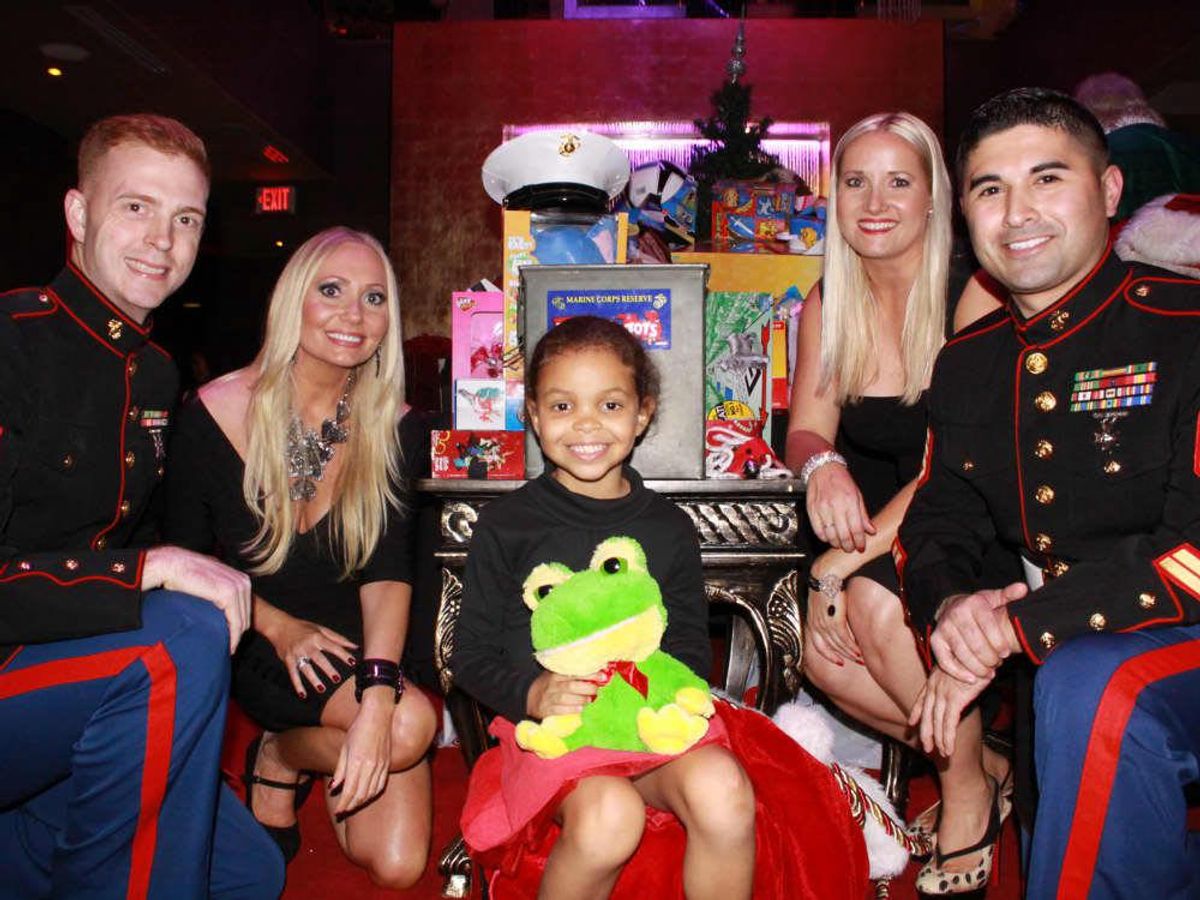 Lori Lemon-Geshay, left, and Nicole Brende with Marines and young Ellie ...