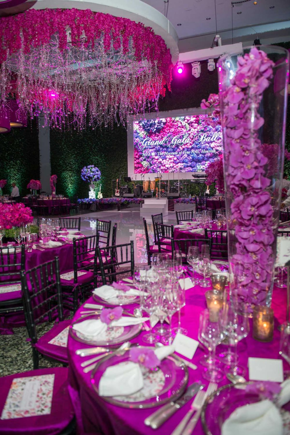 Flowers hung from a large chandelier and large vases of butterfly ...