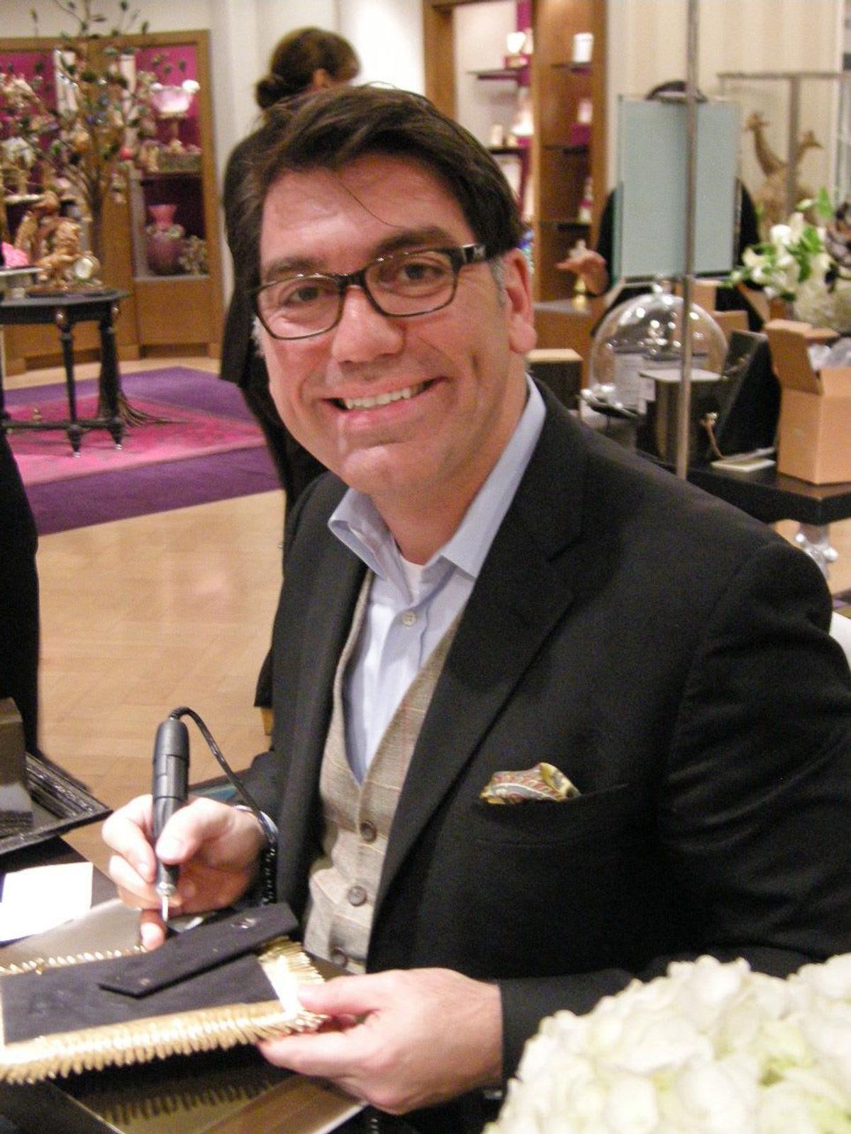 Michael Aram personalizing gifts with his engraved signature at Neiman ...