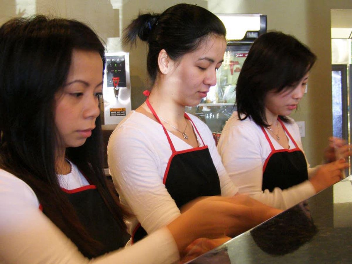 Cindy Dang, left, Tinh Tran and Chau Dang assist in preparations ...