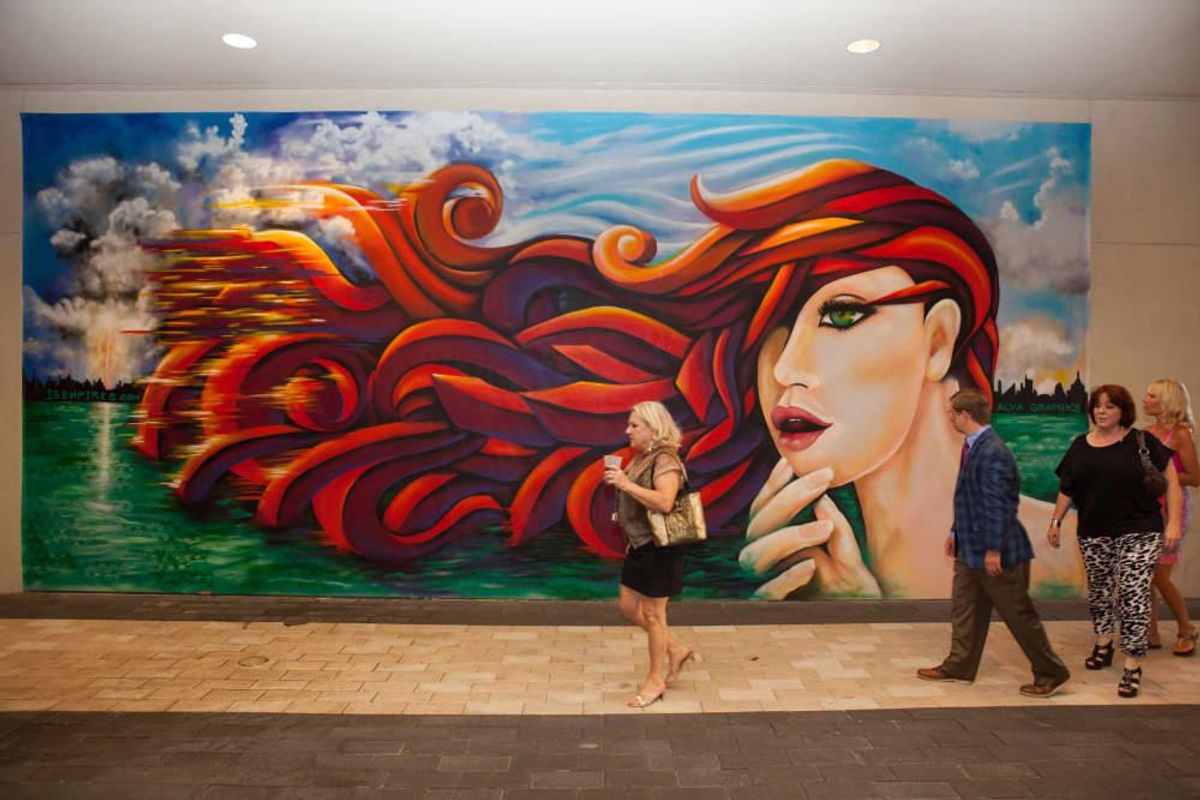 Guests celebrating Muir Fine Art Gallery's "Mural Project" peruse the ...