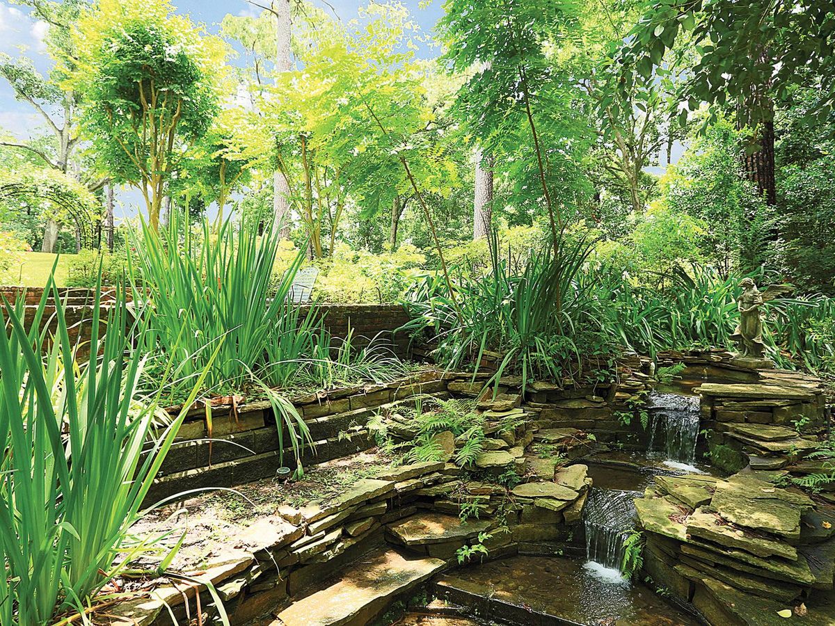 Stacked-stone and brick paths travel from the gardens to the private ...