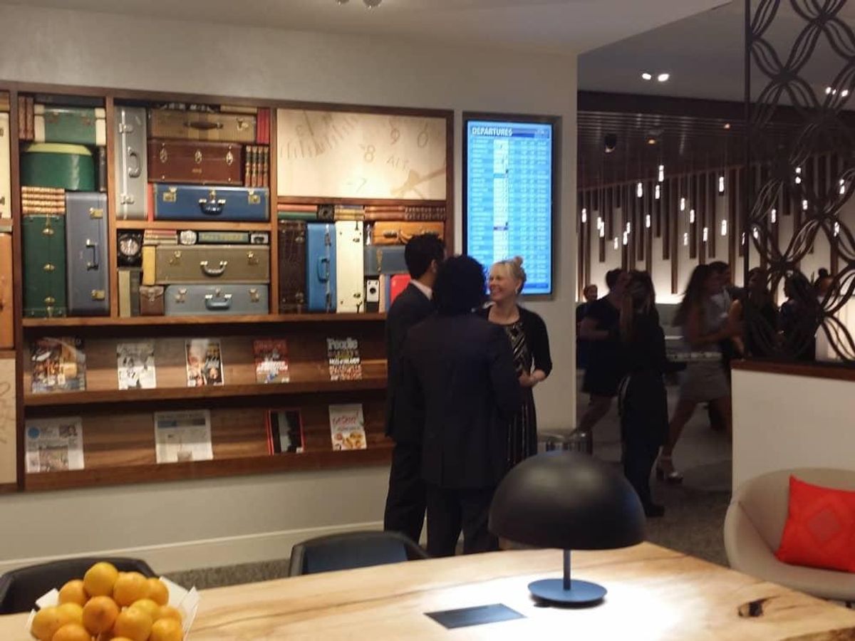 The wall of vintage luggage a Centurion Lounge signature. - CultureMap ...
