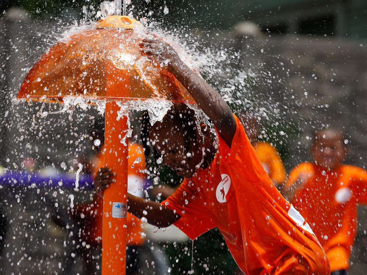 Children playing in a new solar powered splash pad in the Fifth Ward ...