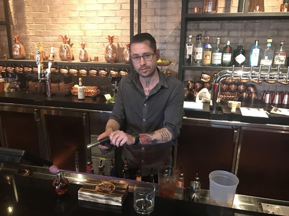 Ben Baxter prepares the Smoke on the Bayou cocktail - CultureMap Houston