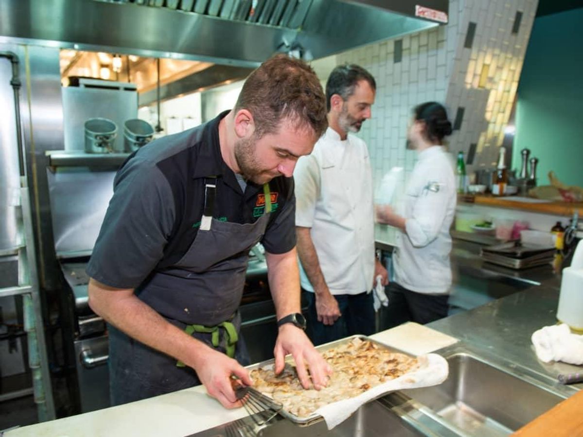 Michael Gulotta prepares his dish. - CultureMap Houston