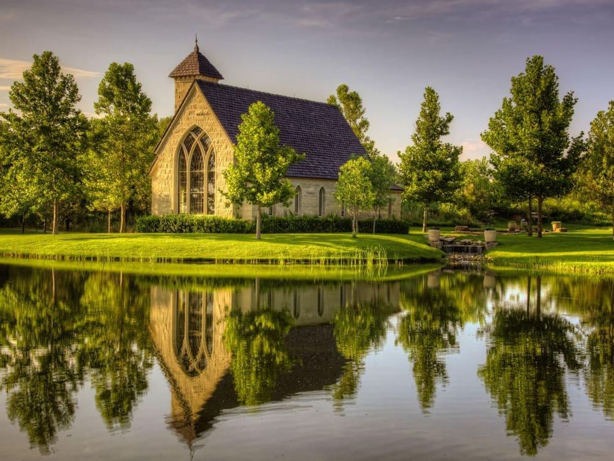 A chapel sits beside a lake at Mesa Vista Ranch. - CultureMap Houston