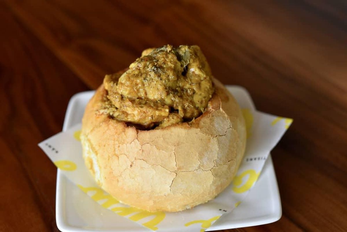 Curry chicken tastes better in a bread bowl. - CultureMap Houston